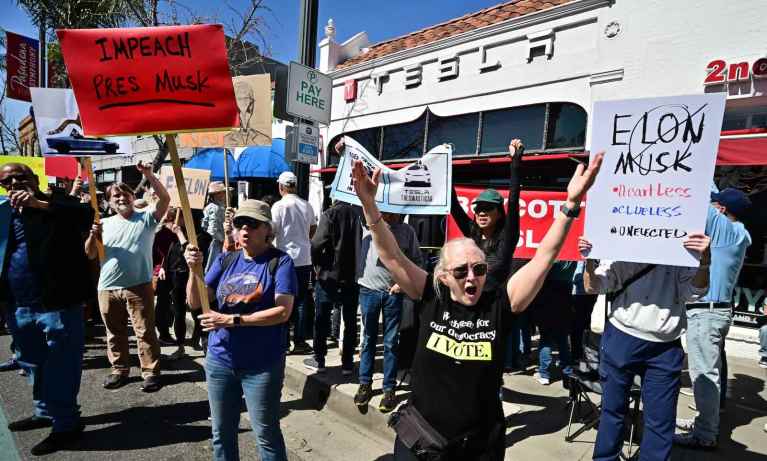 Florida man drives car through crowd of Tesla protesters outside dealership