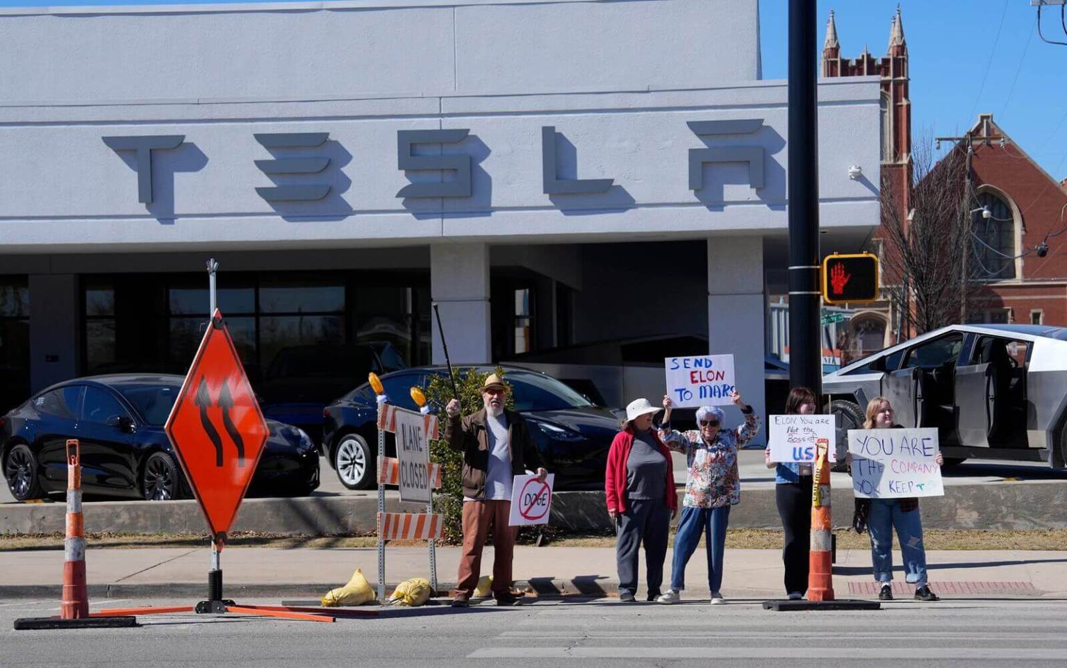 Tesla protestors are wallpapering the brand’s EVs with cheese