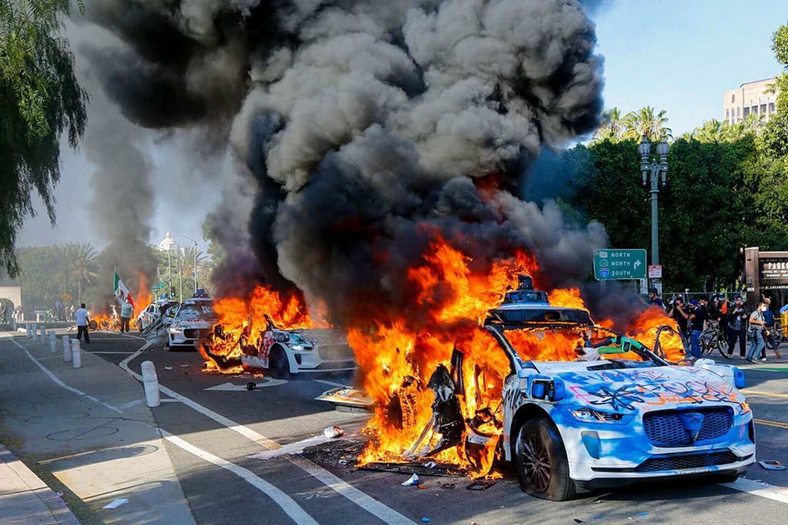 Los Angeles protesters light Waymo cabs on fire