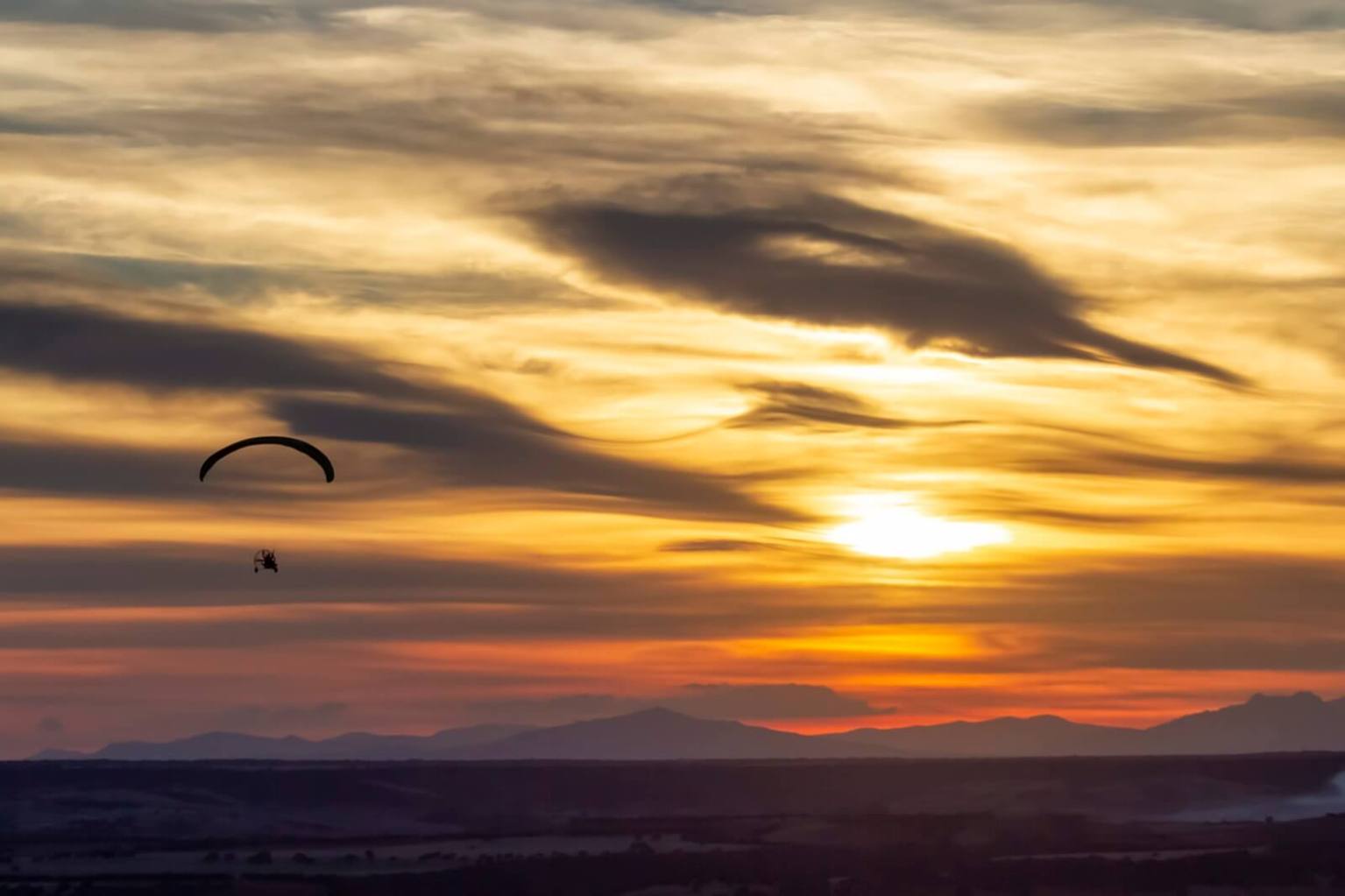 Paraglider sails over a bridge in Grand Forks just to crash into a ...